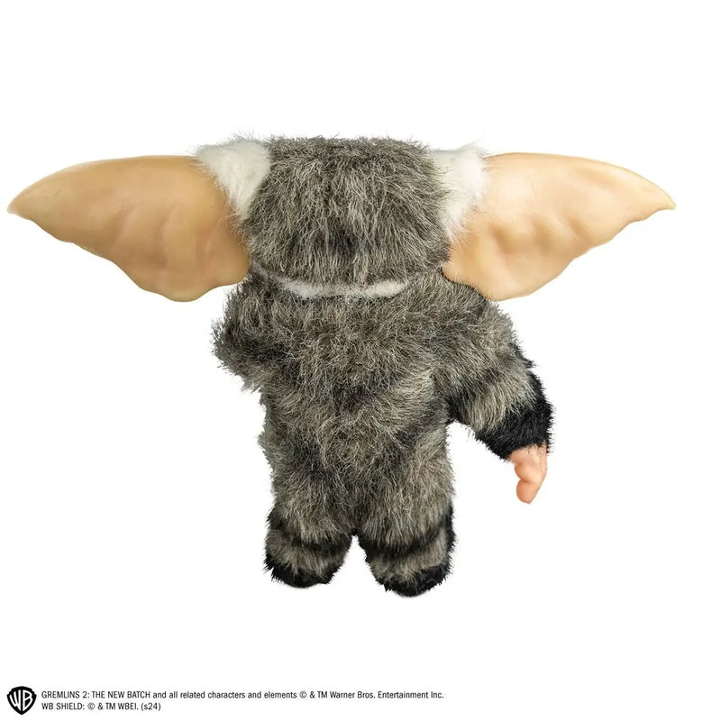 Plush toy resembling a creature with large ears on a white background